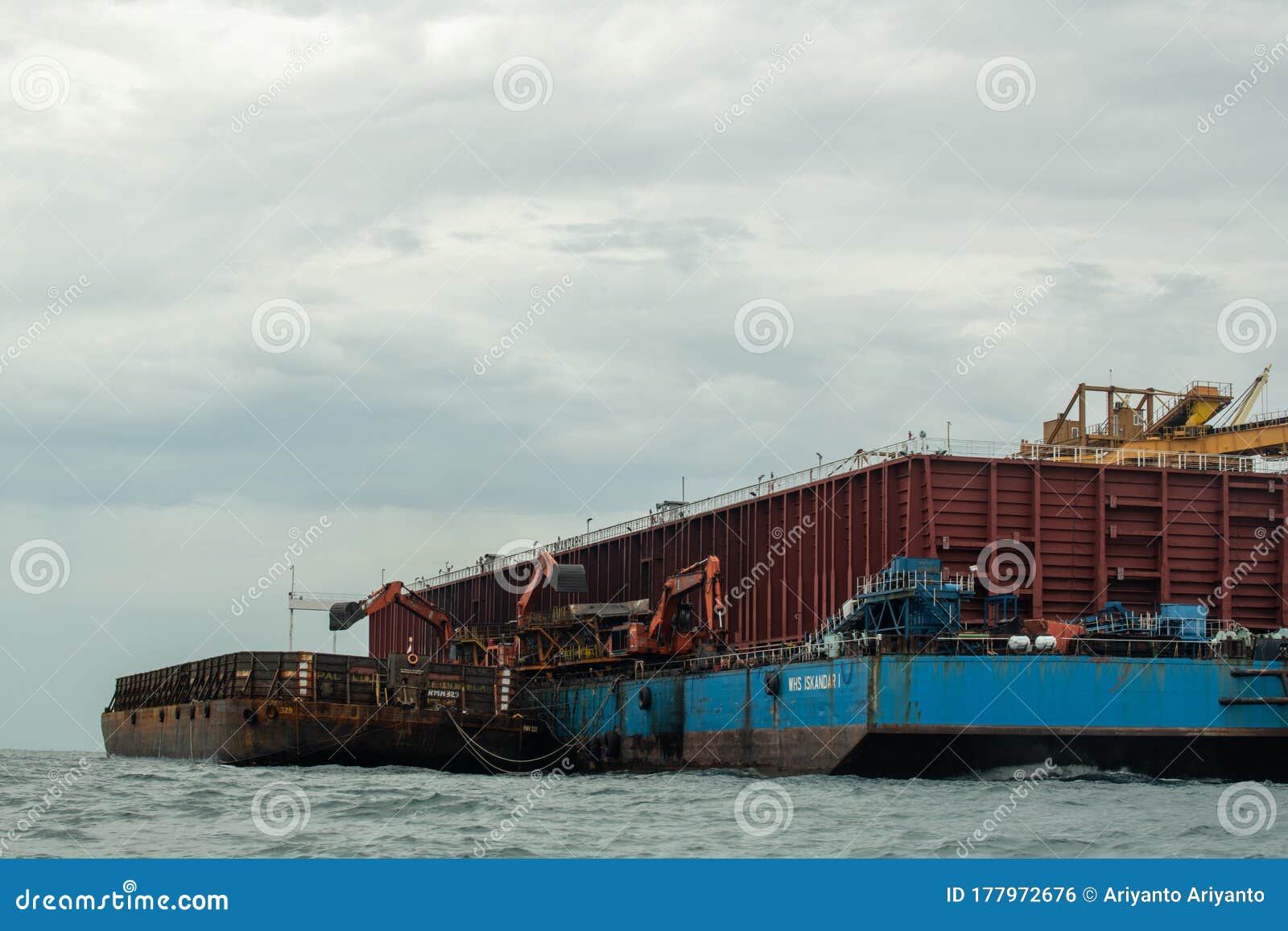 Loading Coal from Cargo Barges Onto a Bulk Vessel Using Ship Cranes ...