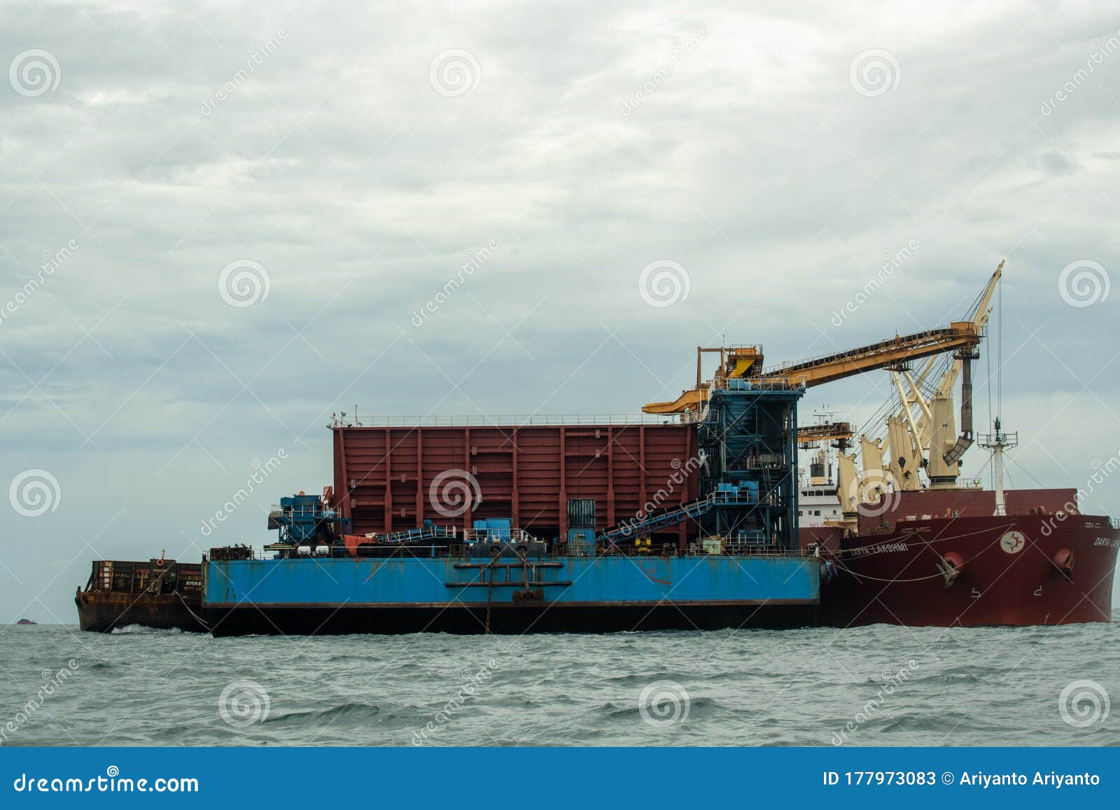 Loading Coal from Cargo Barges Onto a Bulk Vessel Using Ship Cranes ...
