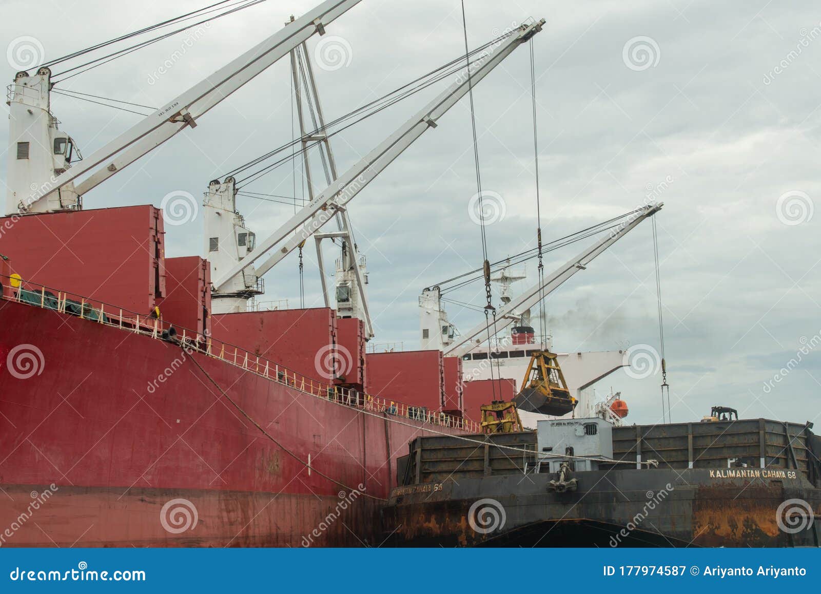 Loading Coal from Cargo Barges Onto a Bulk Vessel Using Ship Cranes ...