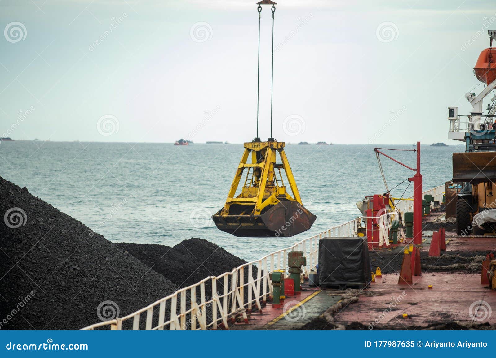 Loading Coal from Cargo Barges Onto a Bulk Vessel Using Ship Cranes in ...