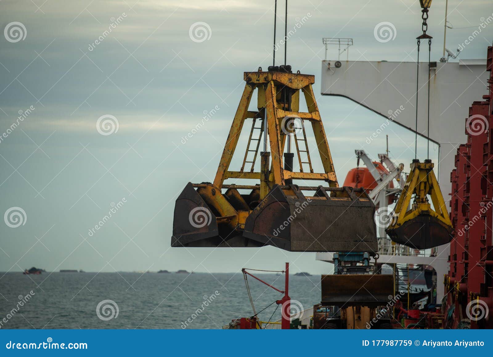 Loading Coal from Cargo Barges Onto a Bulk Vessel Using Ship Cranes in ...