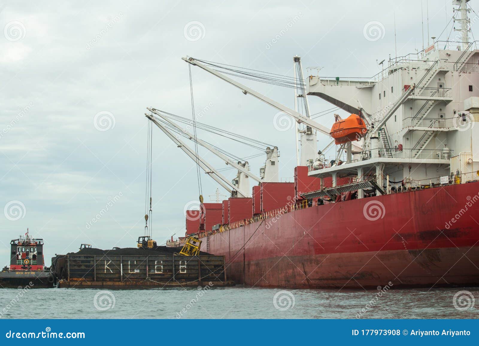 Loading Coal from Cargo Barges Onto a Bulk Vessel Using Ship Cranes ...