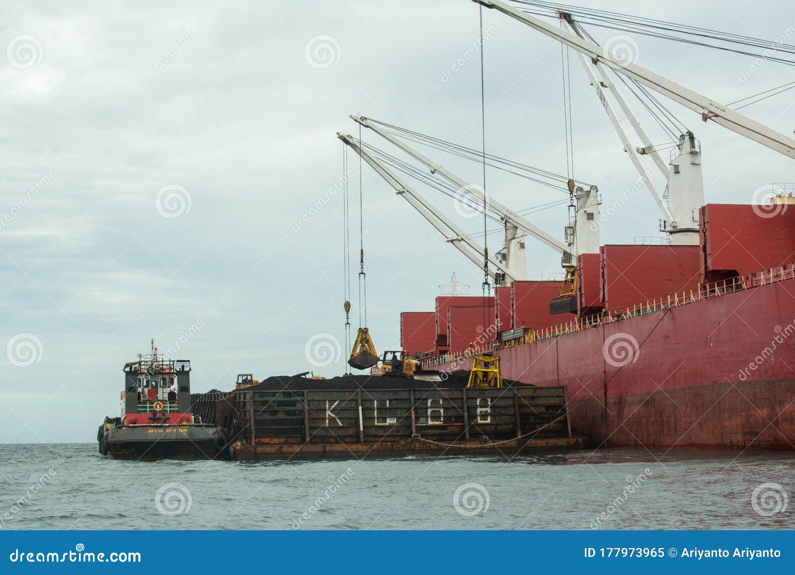 Loading Coal from Cargo Barges Onto a Bulk Vessel Using Ship Cranes ...