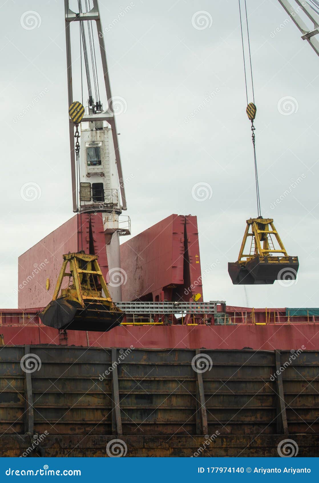 Loading Coal from Cargo Barges Onto a Bulk Vessel Using Ship Cranes ...