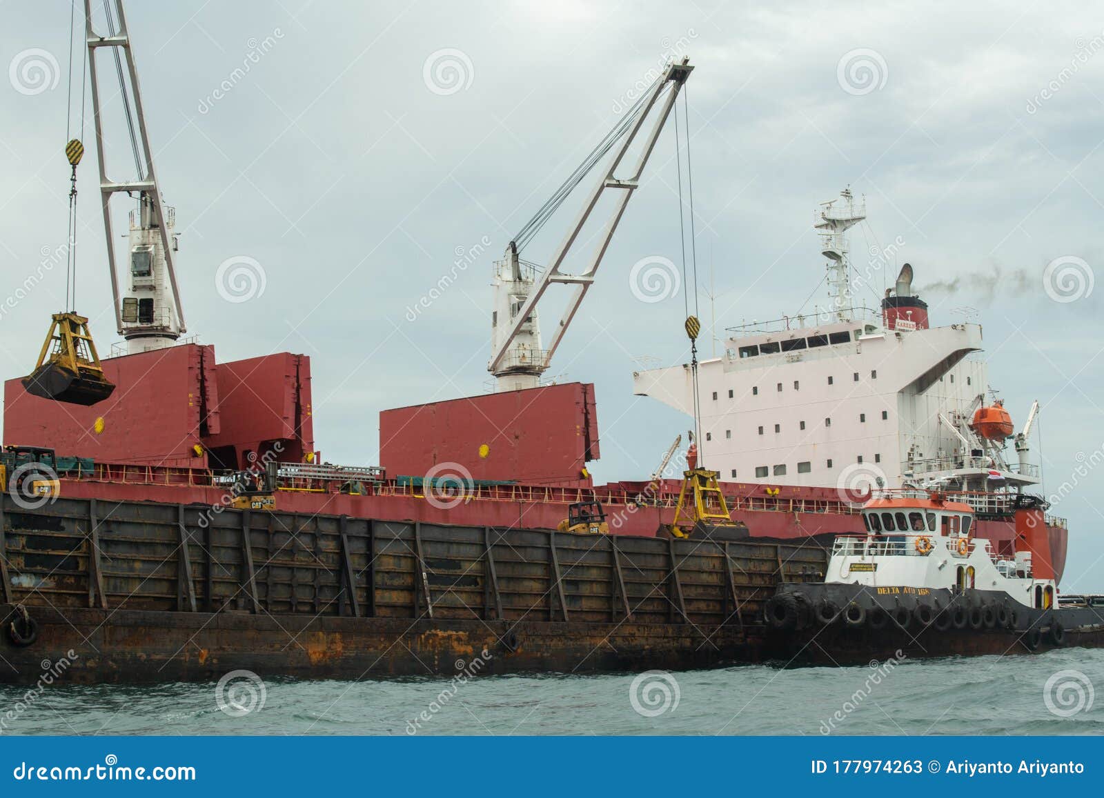 Loading Coal from Cargo Barges Onto a Bulk Vessel Using Ship Cranes ...