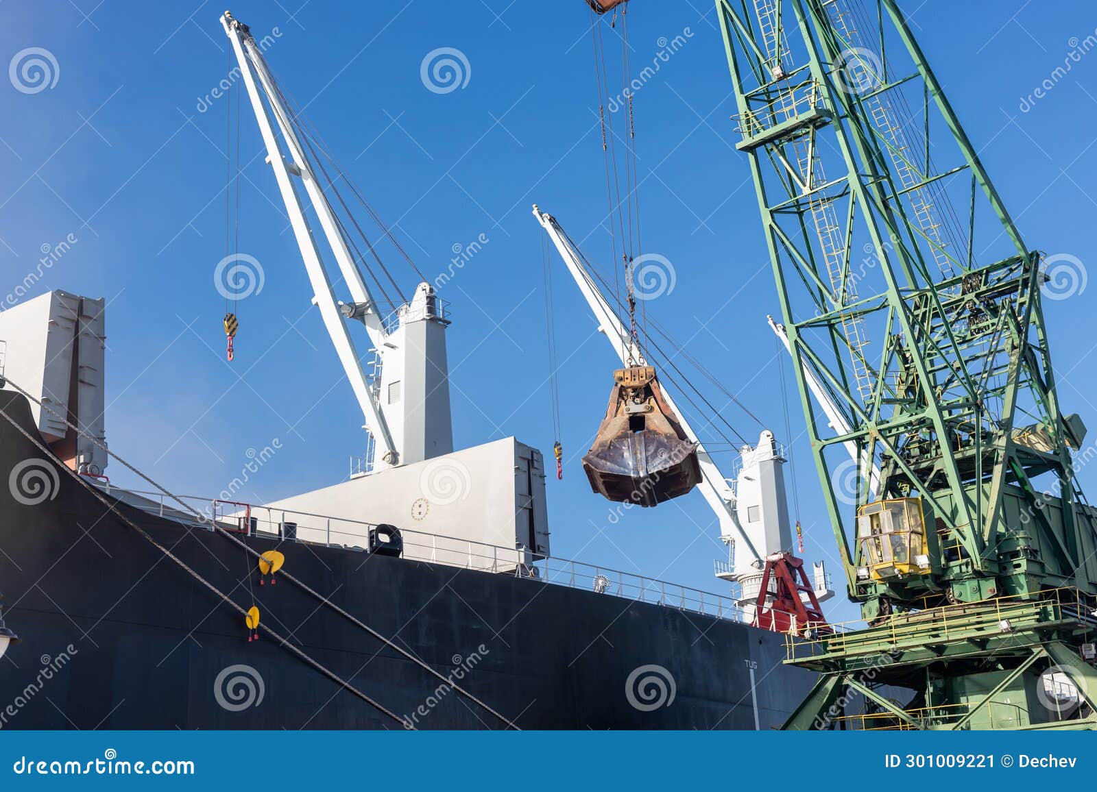 Loading Dry Cargo Ship by Cranes in Port. Loading into Holds of Sea ...