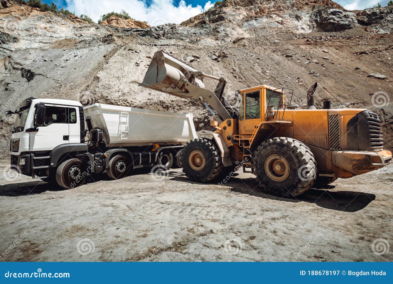 Wheel Loader Loading Gravel and Sand into Dumper Trucks. Machinery and ... Wheel Loader Loading Gravel and Sand into Dumper Trucks. Machinery and ...