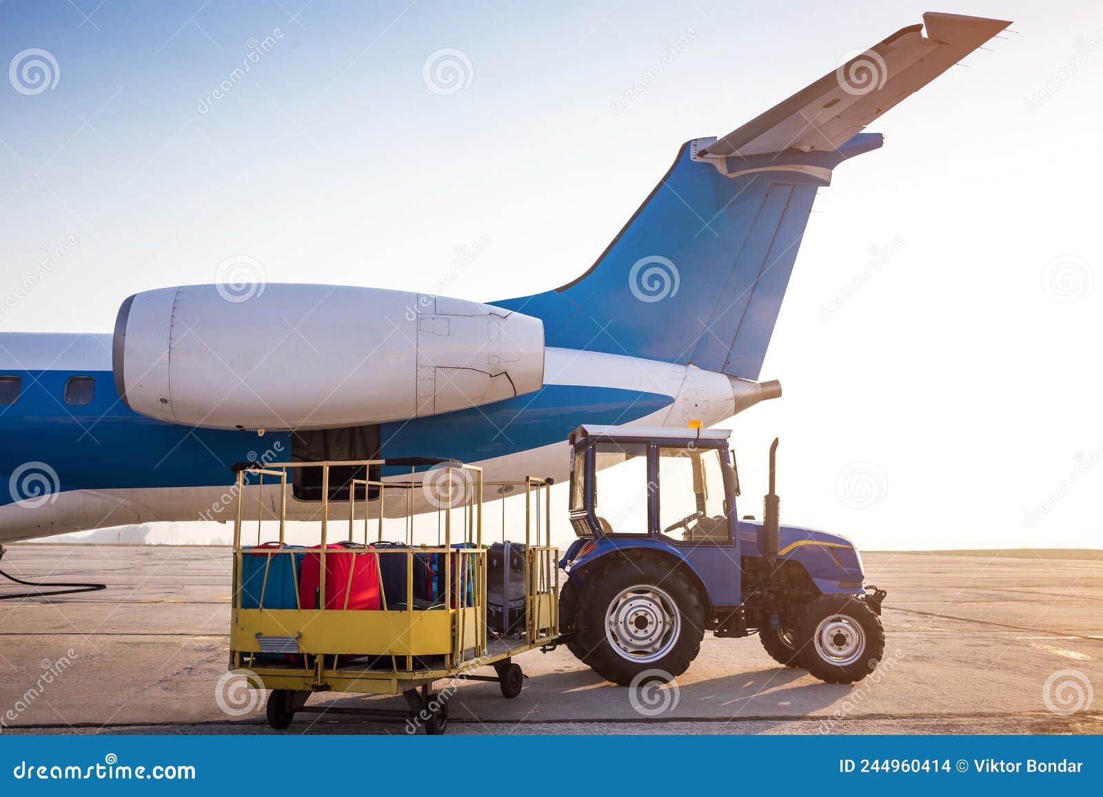 Loading Luggage on the Plane. Transportation of Baggage in Trailers To ...