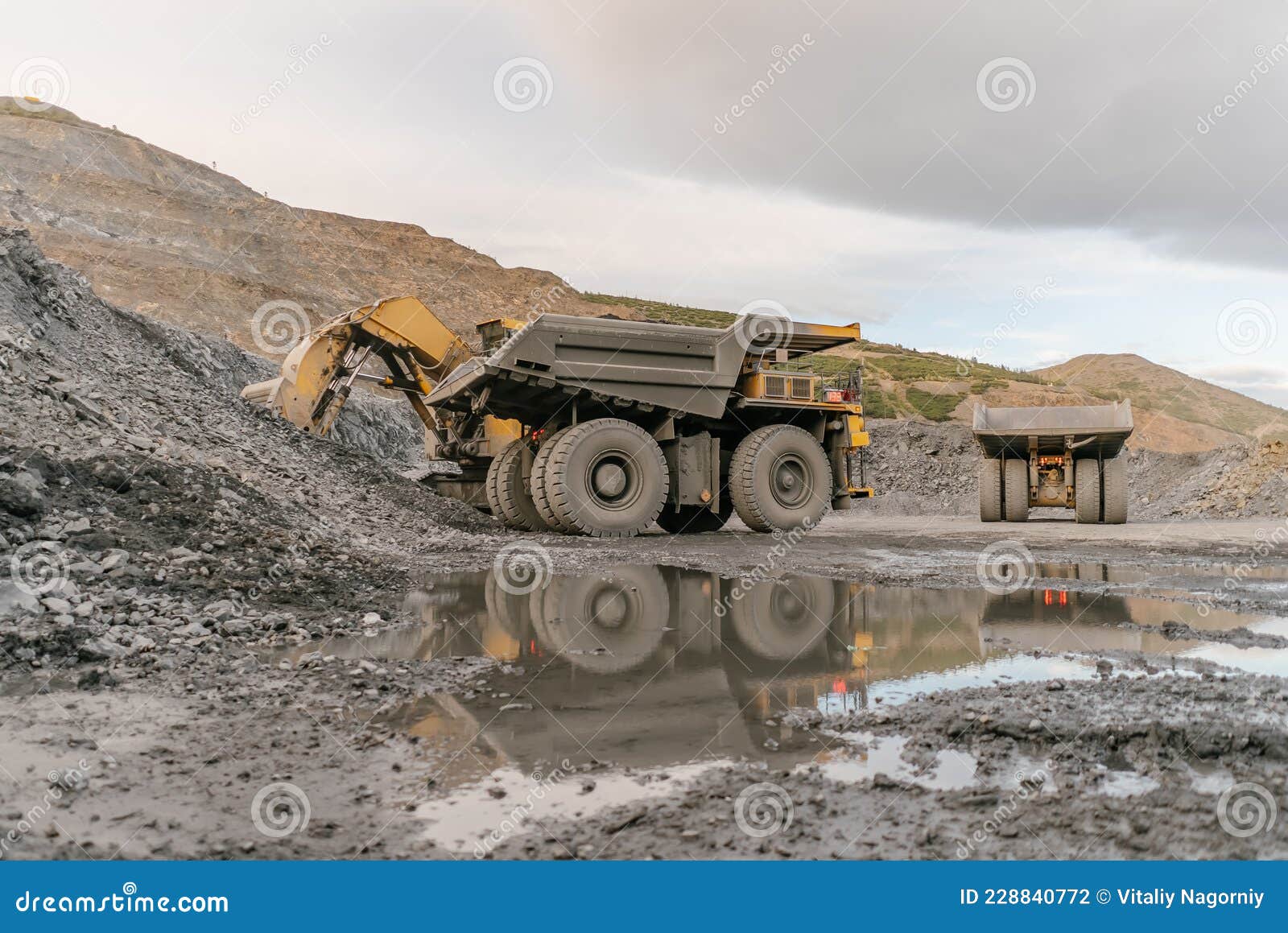 Dump Trucks Unloading Garbage Over Vast Landfill. Smoking Industrial ...