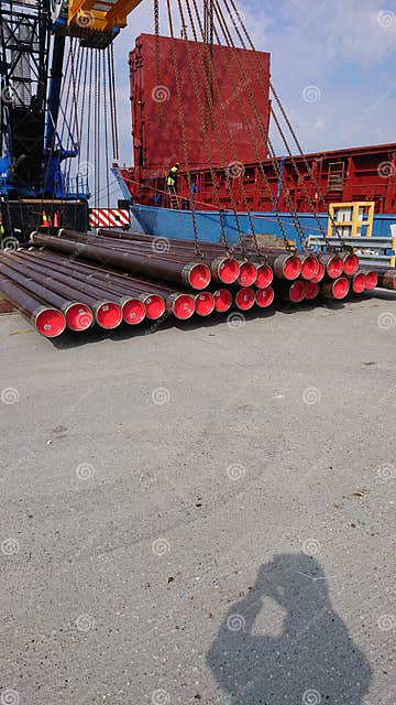 Loading pipes on ship stock photo. Image of loading - 135066544