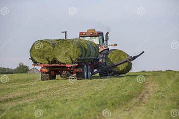 Loading and Moving Round Bales of Hay Using Auto Loader Trailer. Stock ...