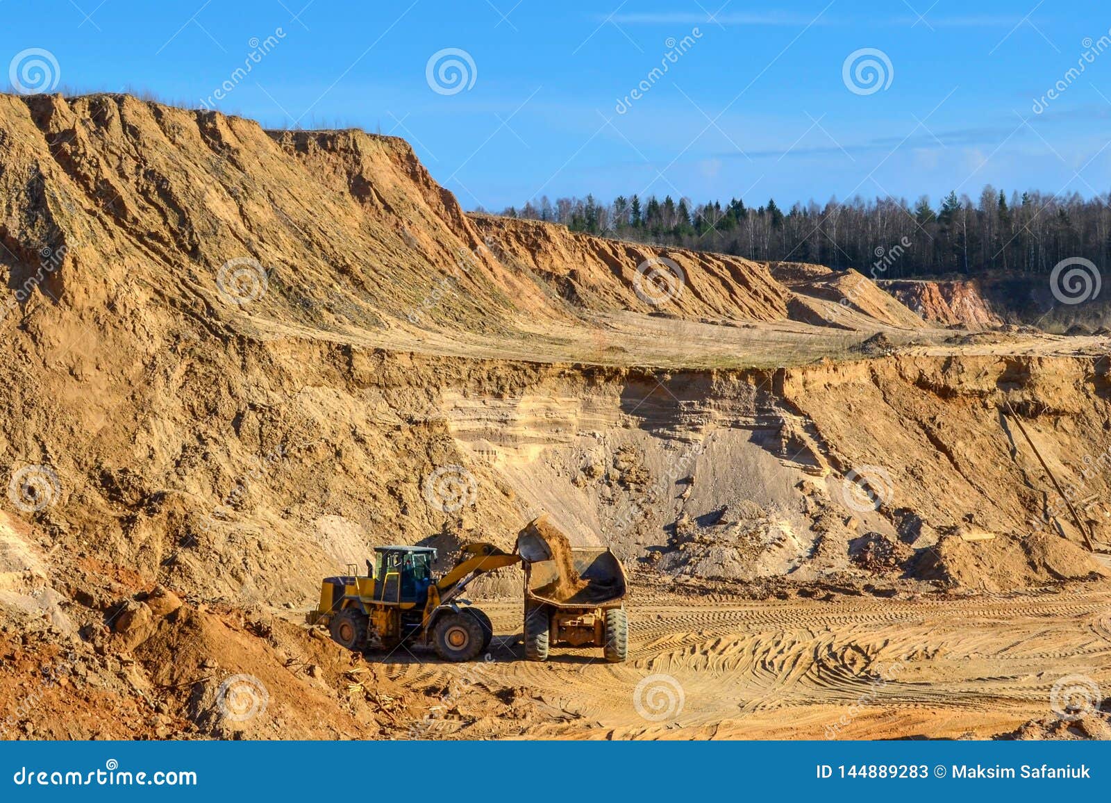 Loading Sand with a Wheeled Front Loader with a Large Bucket into a ...