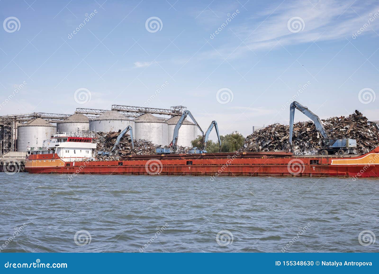 Loading of Scrap Metal on a Ship in the Port. the Barge is Being Loaded ...