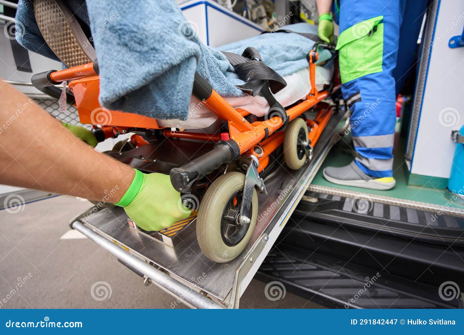Loading a Stretcher with a Patient into an Ambulance Stock Image ...