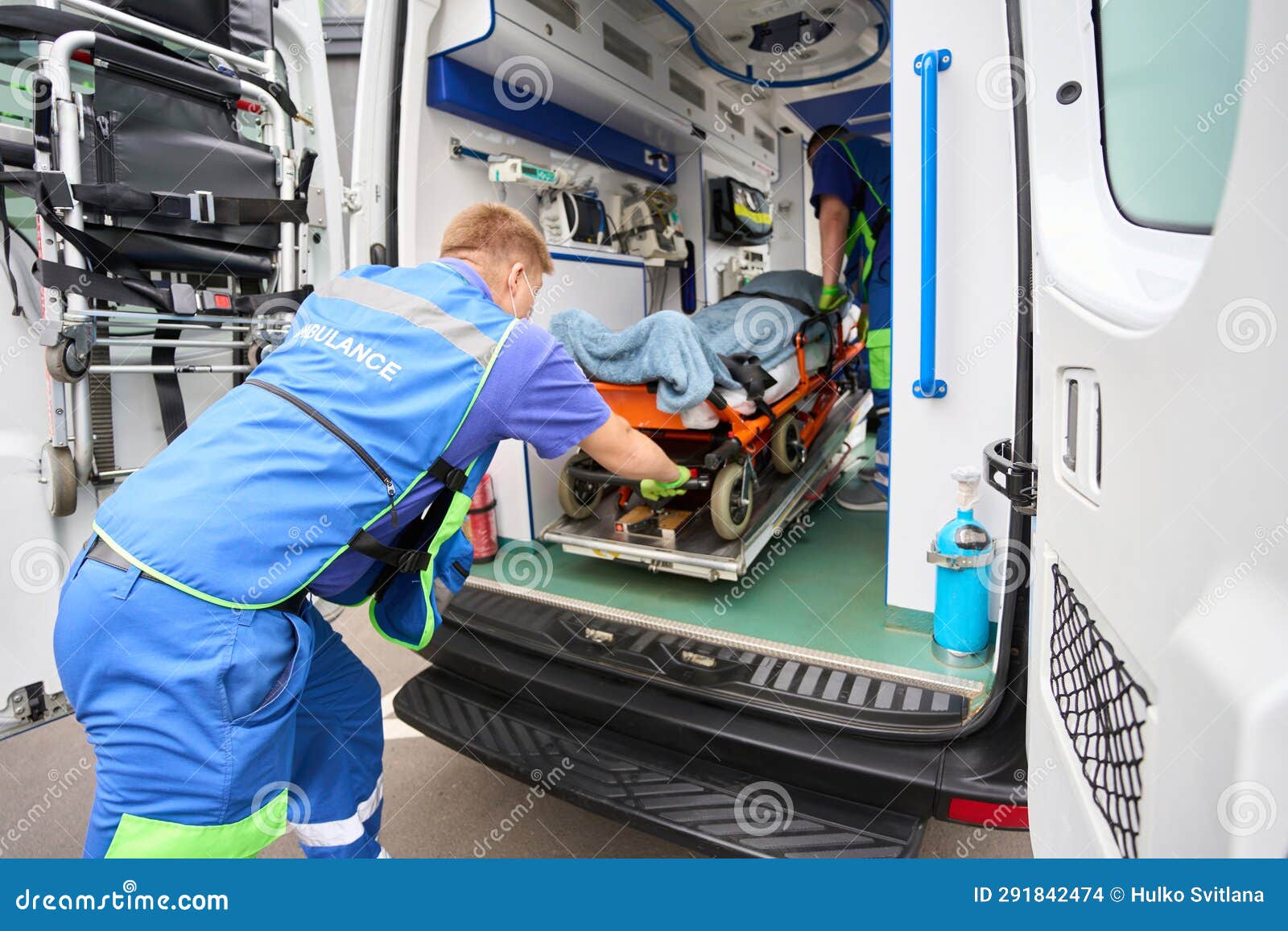 Loading a Stretcher with a Patient into a Modern Ambulance Stock Photo ...