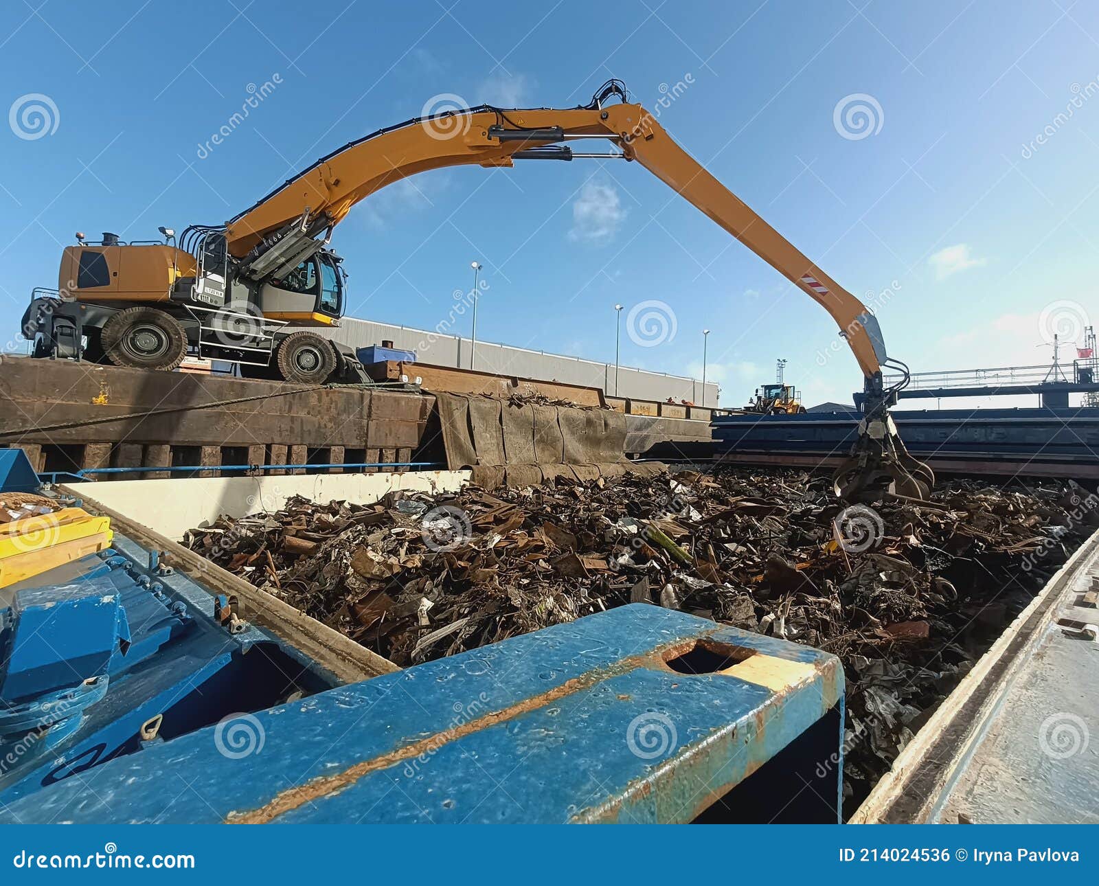 A Loading and Unloading Crane Unloads Metal and Metal Waste from the ...