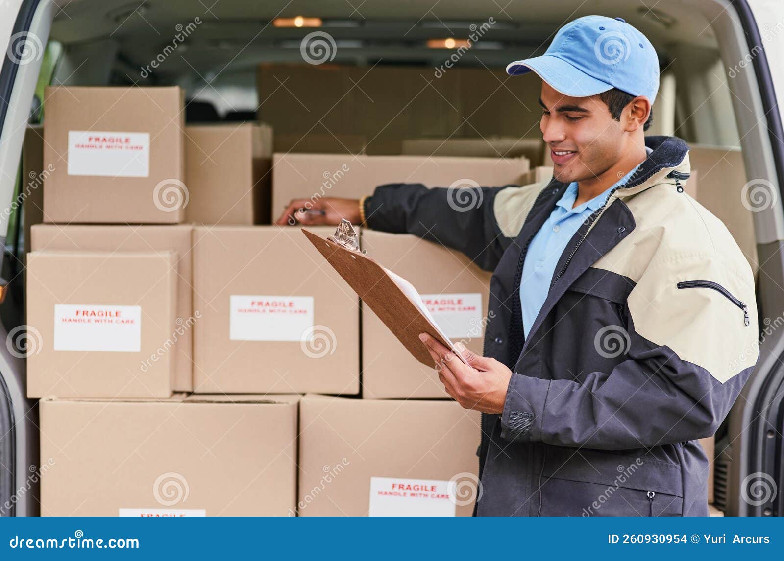 Loading the Van for His Day of Deliveries. a Delivery Man Standing Next ...