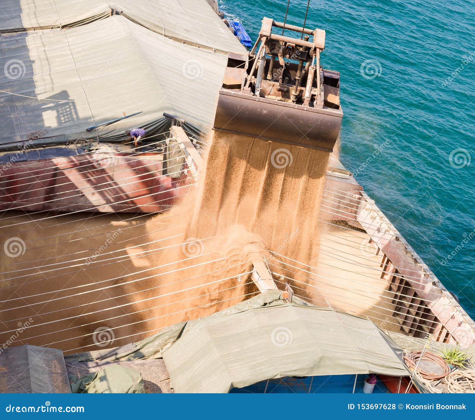 Loading Wheat on Cargo Ship with Crane and Bucket. Shipment from a ...
