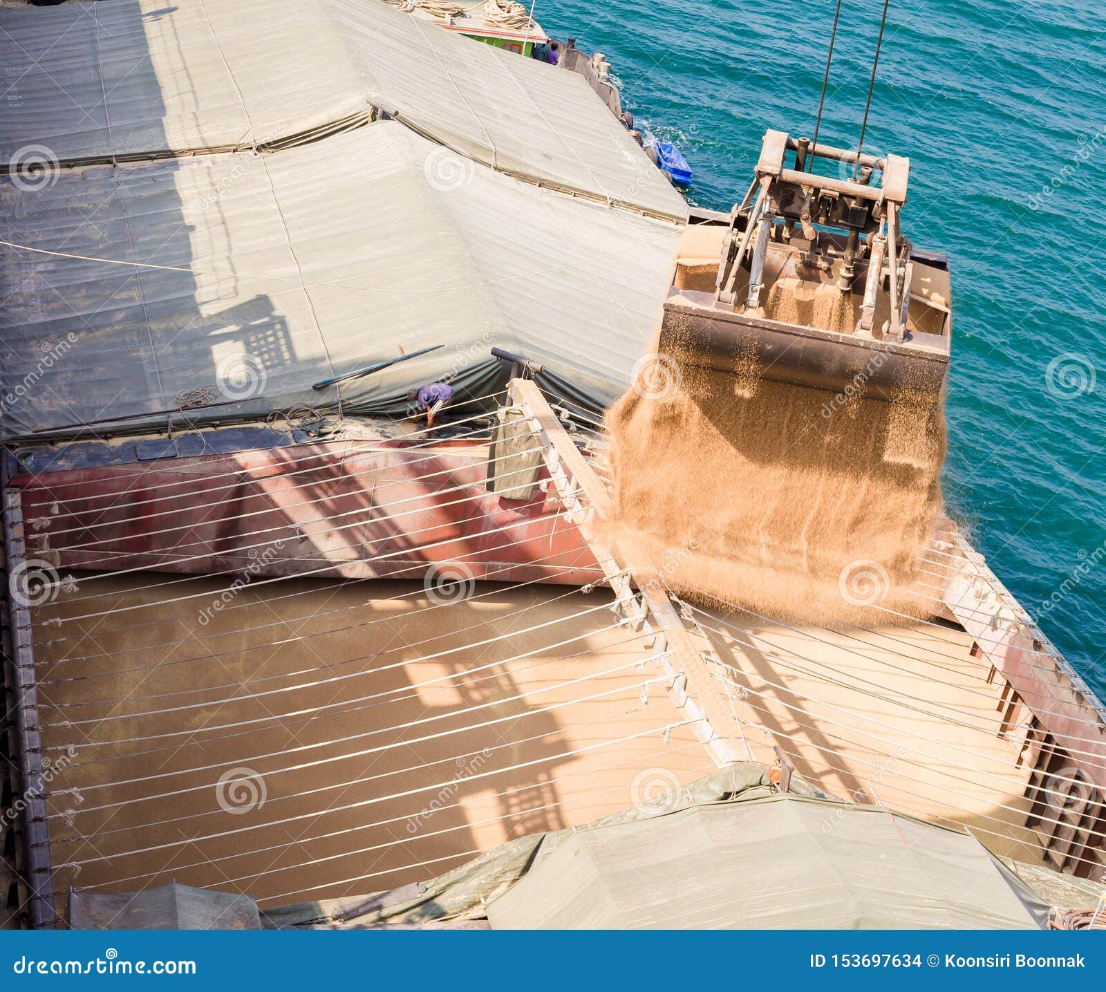Loading Wheat on Cargo Ship with Crane and Bucket. Shipment from a ...