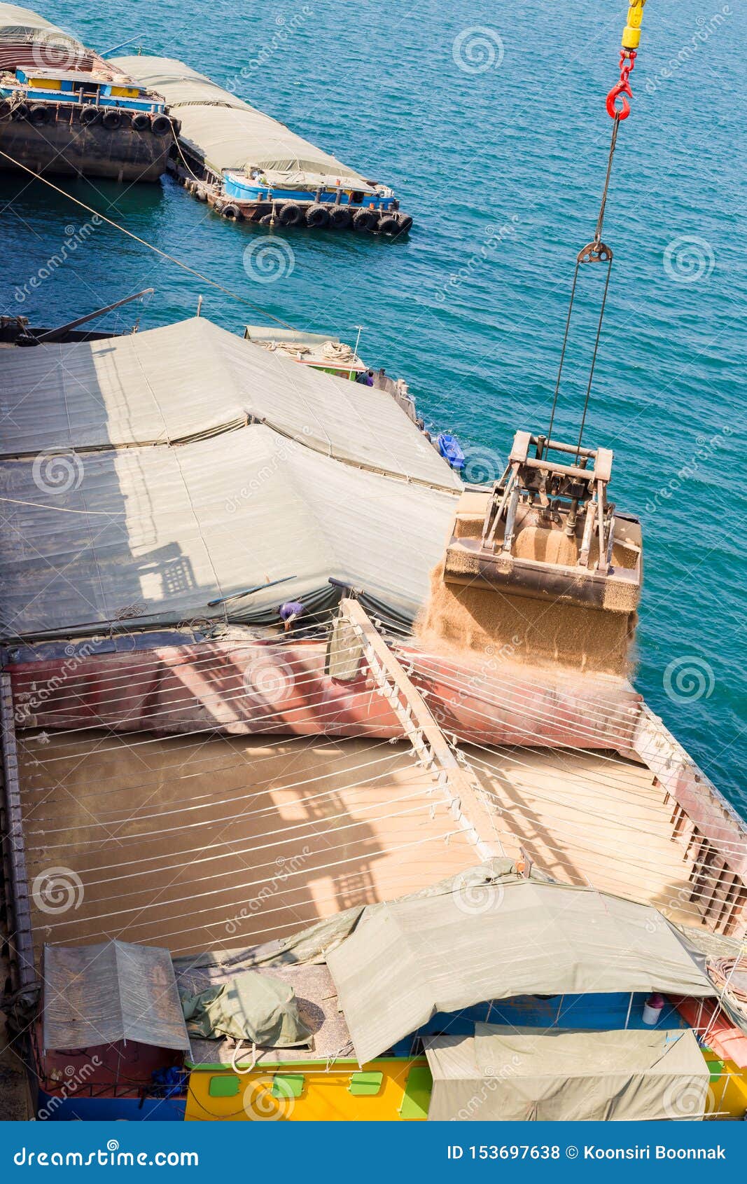 Loading Wheat on Cargo Ship with Crane and Bucket. Shipment from a ...