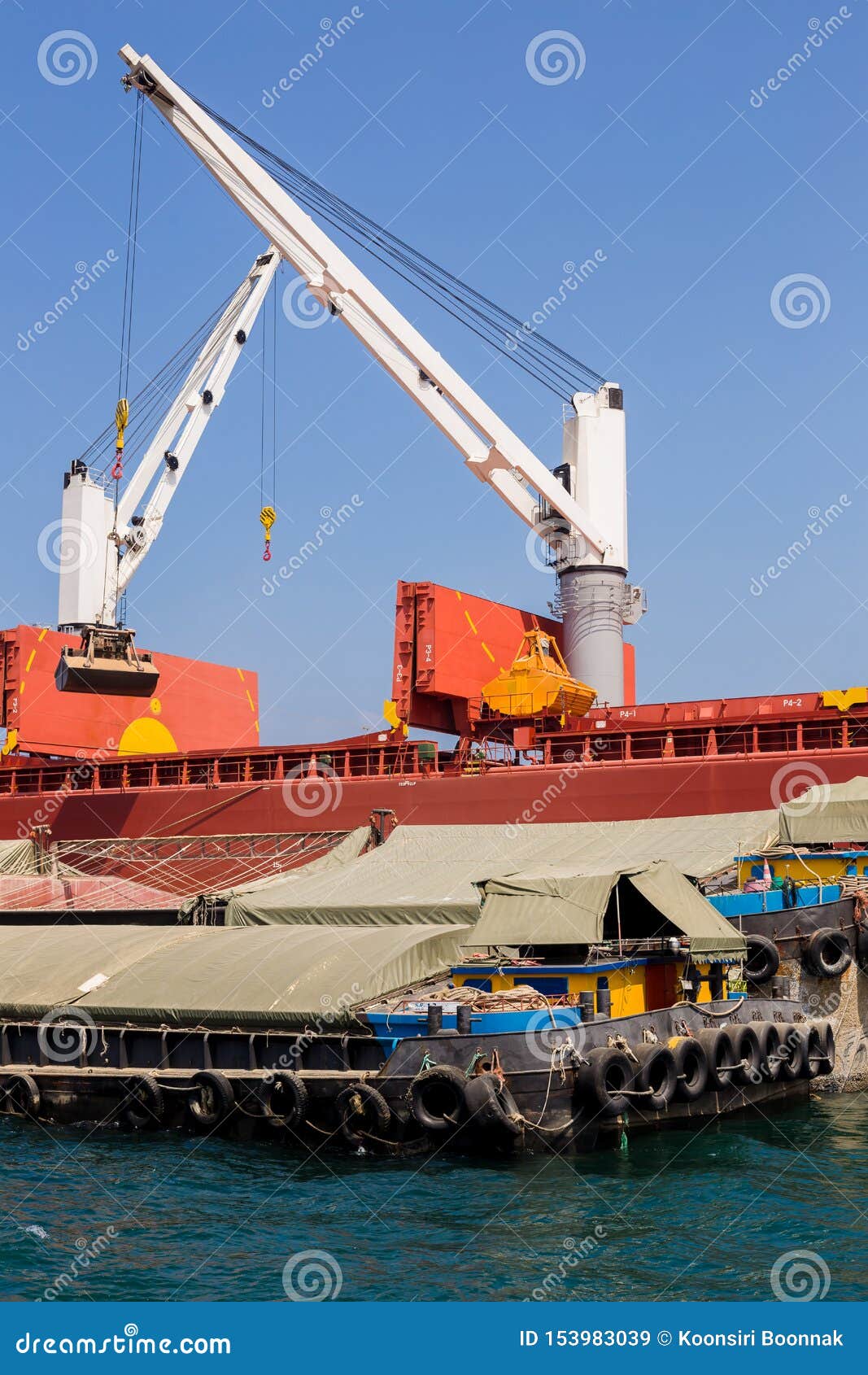 Loading Wheat on Cargo Ship with Crane and Bucket. Shipment from a ...