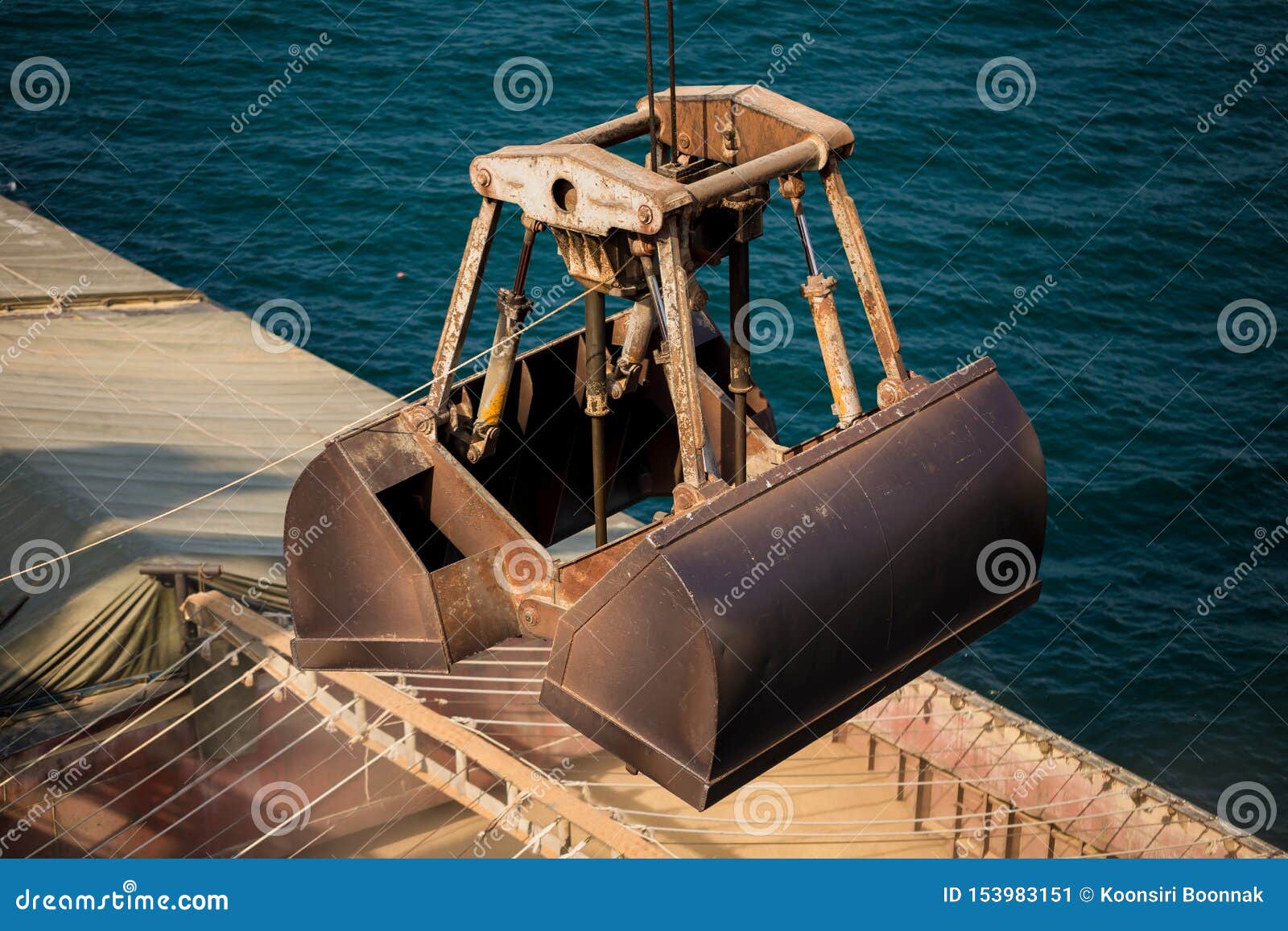 Loading Wheat on Cargo Ship with Crane and Bucket. Shipment from a ...