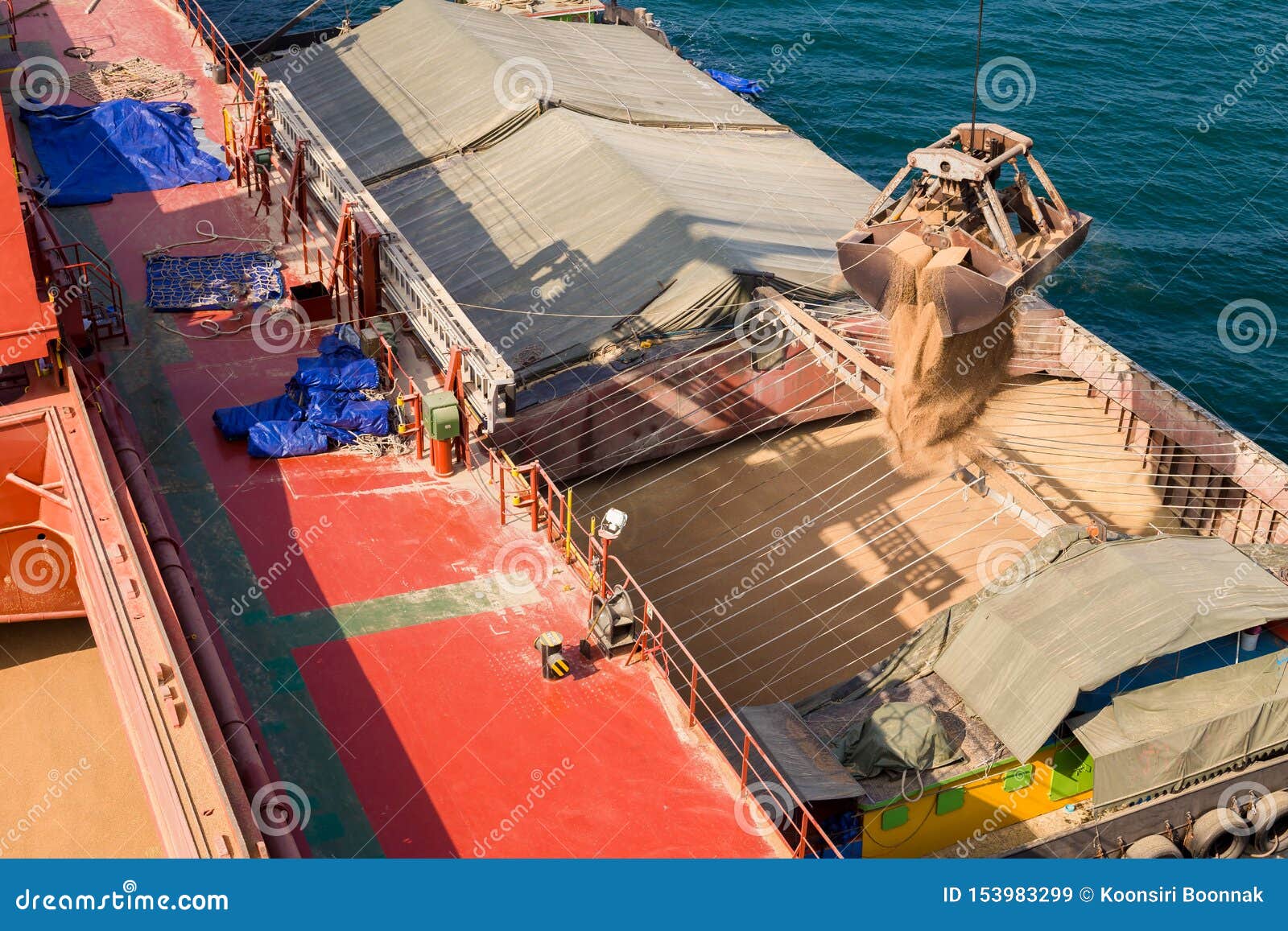 Loading Wheat on Cargo Ship with Crane and Bucket. Shipment from a ...