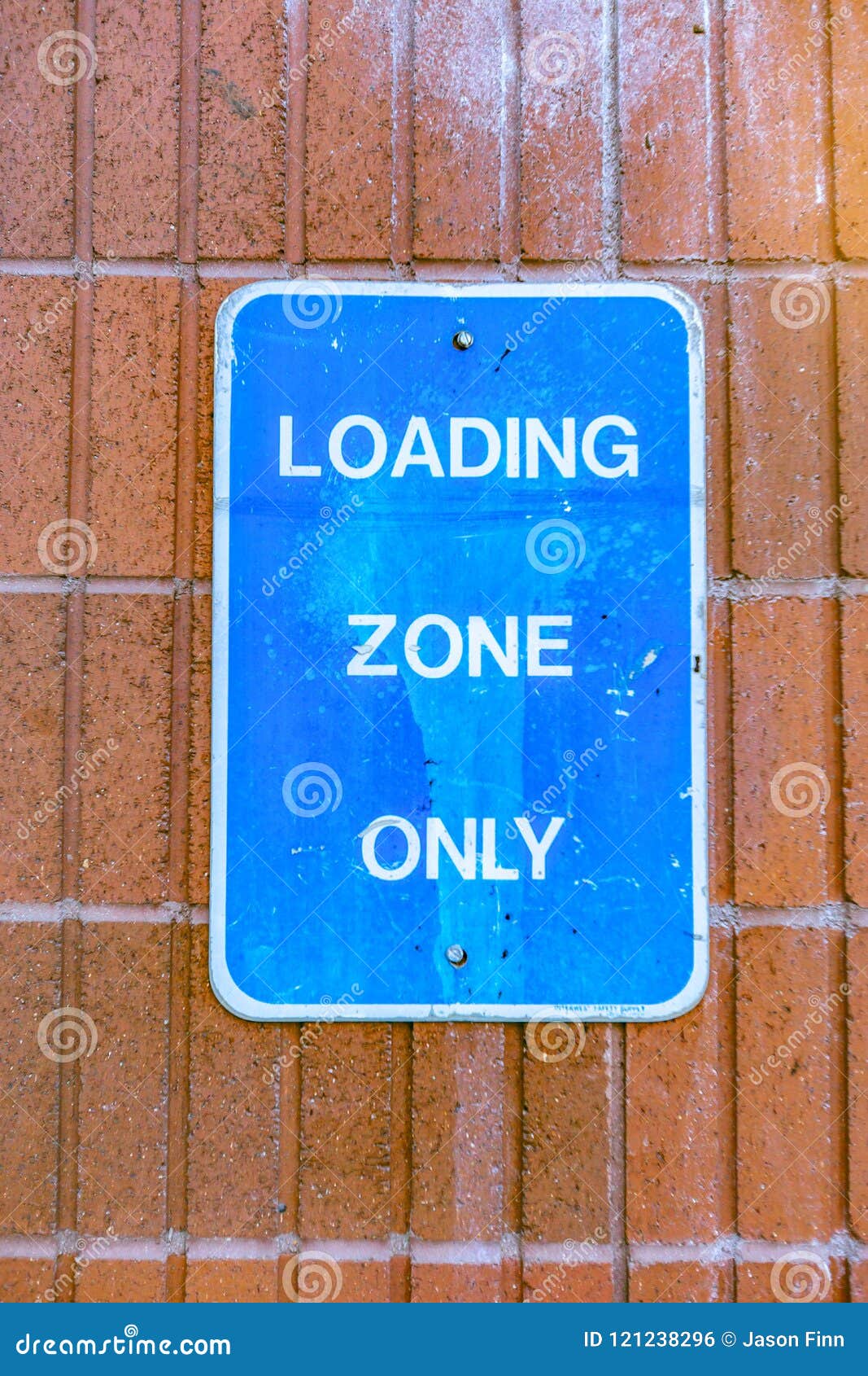 Loading Zone only Blue Sign Against Brick Stock Photo - Image of ...