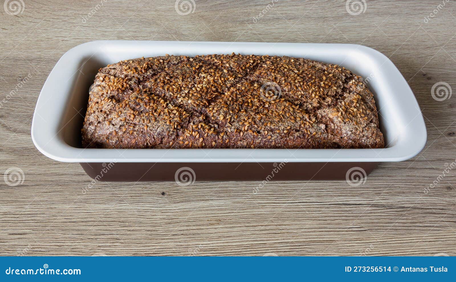 A Loaf of Dark Bread in a Baking Tin on the Table Stock Photo - Image ...