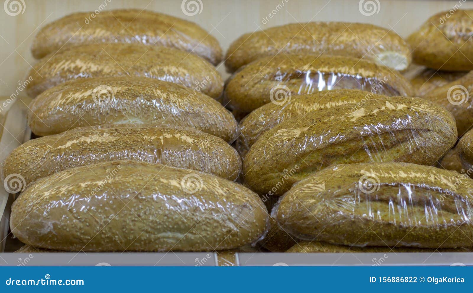 Loafs of Fresh Grain Bread Wrapped in Polyethylene on a Pallet with ...