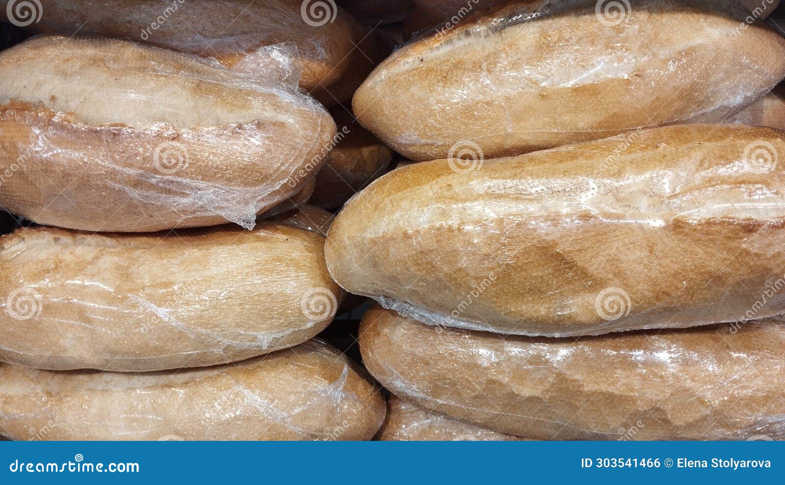 Loaves of White Bread in the Store in Transparent Packaging are Stacked ...