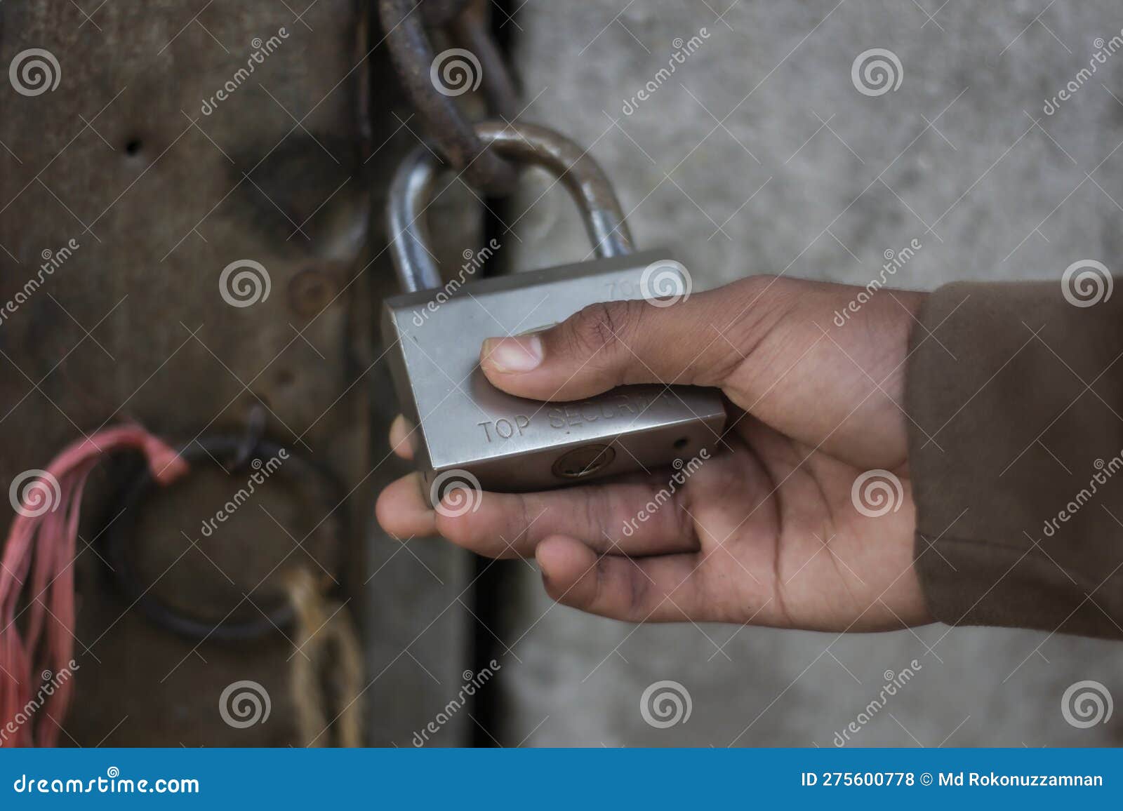 A Lock Hangs on a Door and a Person Holds the Lock Stock Photo - Image ...