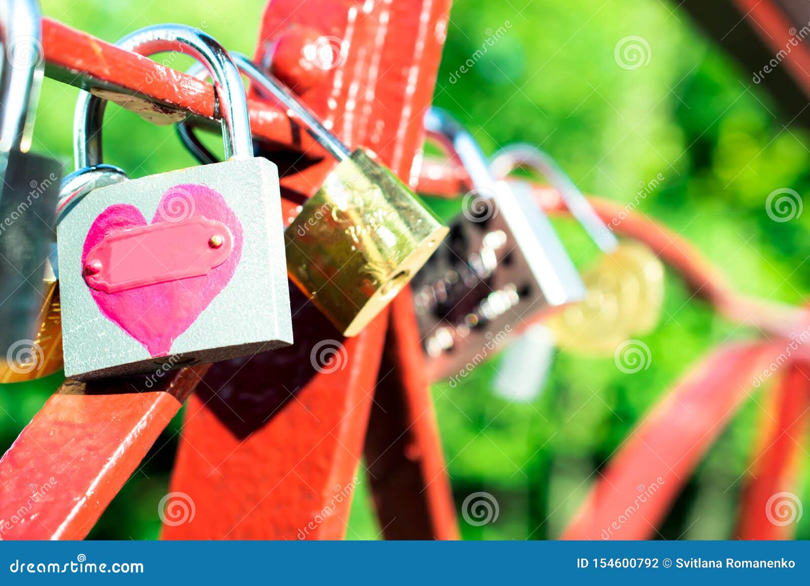 Lock with a Heart Painted on it is Fixed on the Railing of the Bridge ...