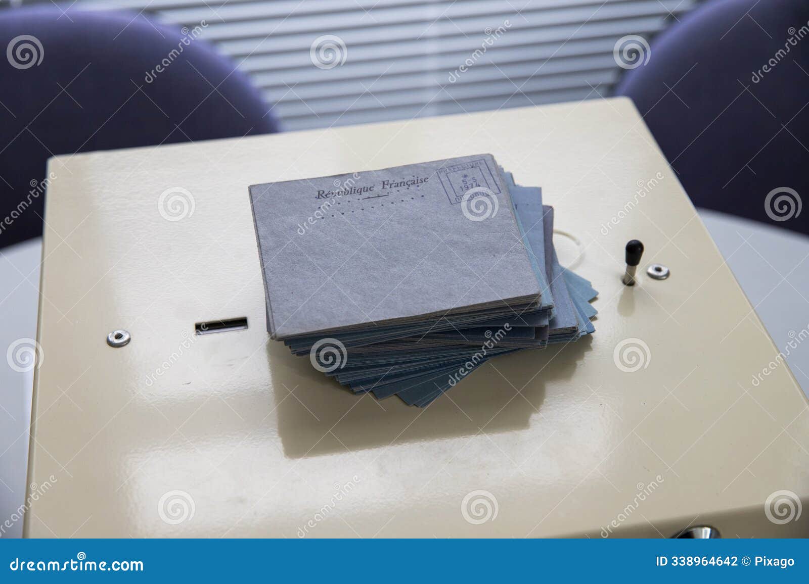 A Locked Transparent Ballot Box with a Stack of Blue Envelopes on Top ...