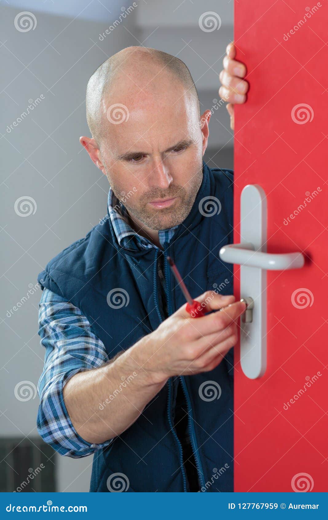 Locksmith fixing a door stock image. Image of maintenance - 127767959