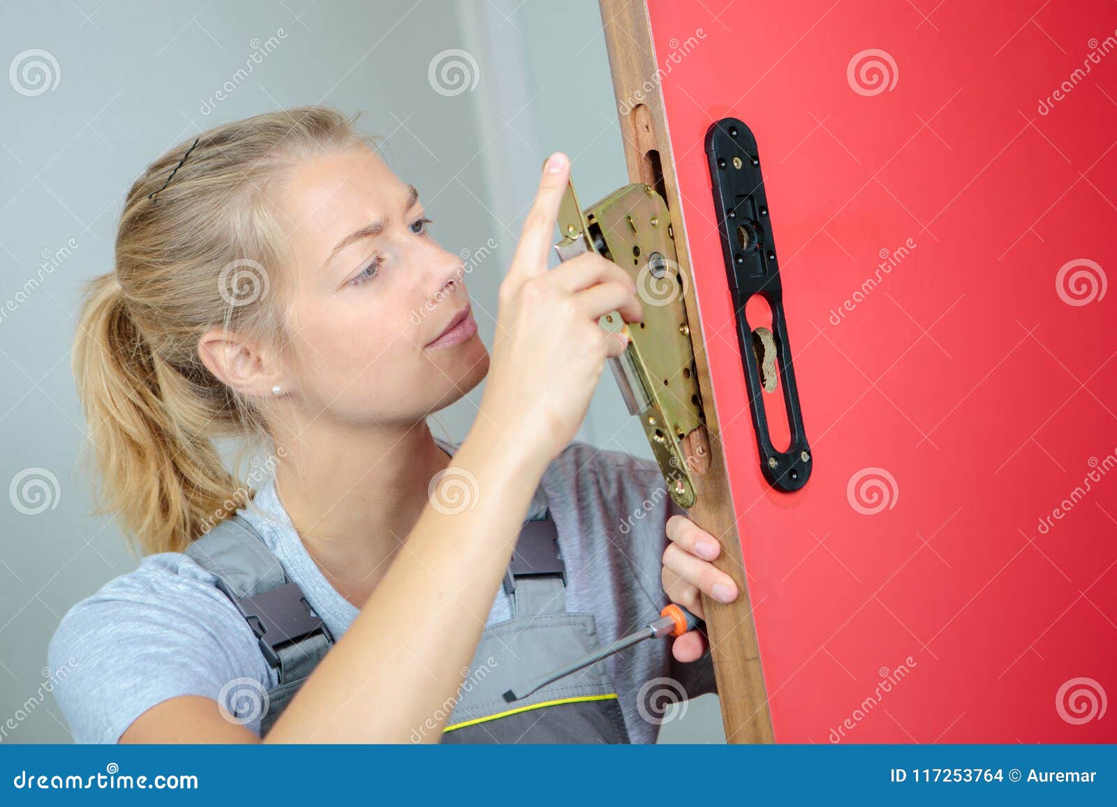 Locksmith fixing a lock stock photo. Image of building - 117253764