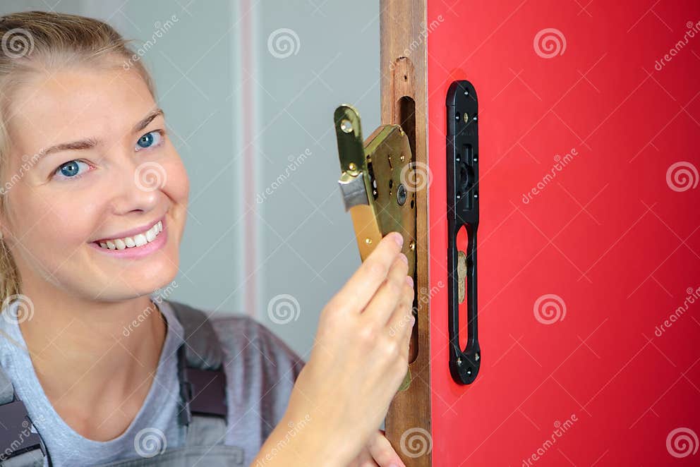 Locksmith fixing a lock stock photo. Image of woman - 130815368