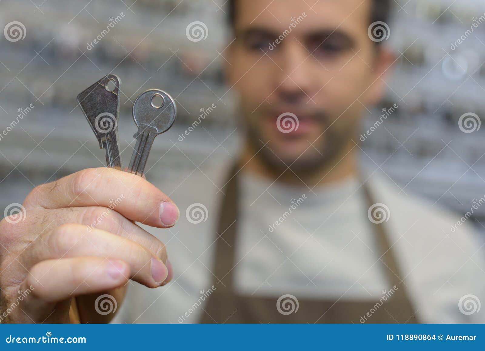 Locksmith holding two keys stock photo. Image of working - 118890864