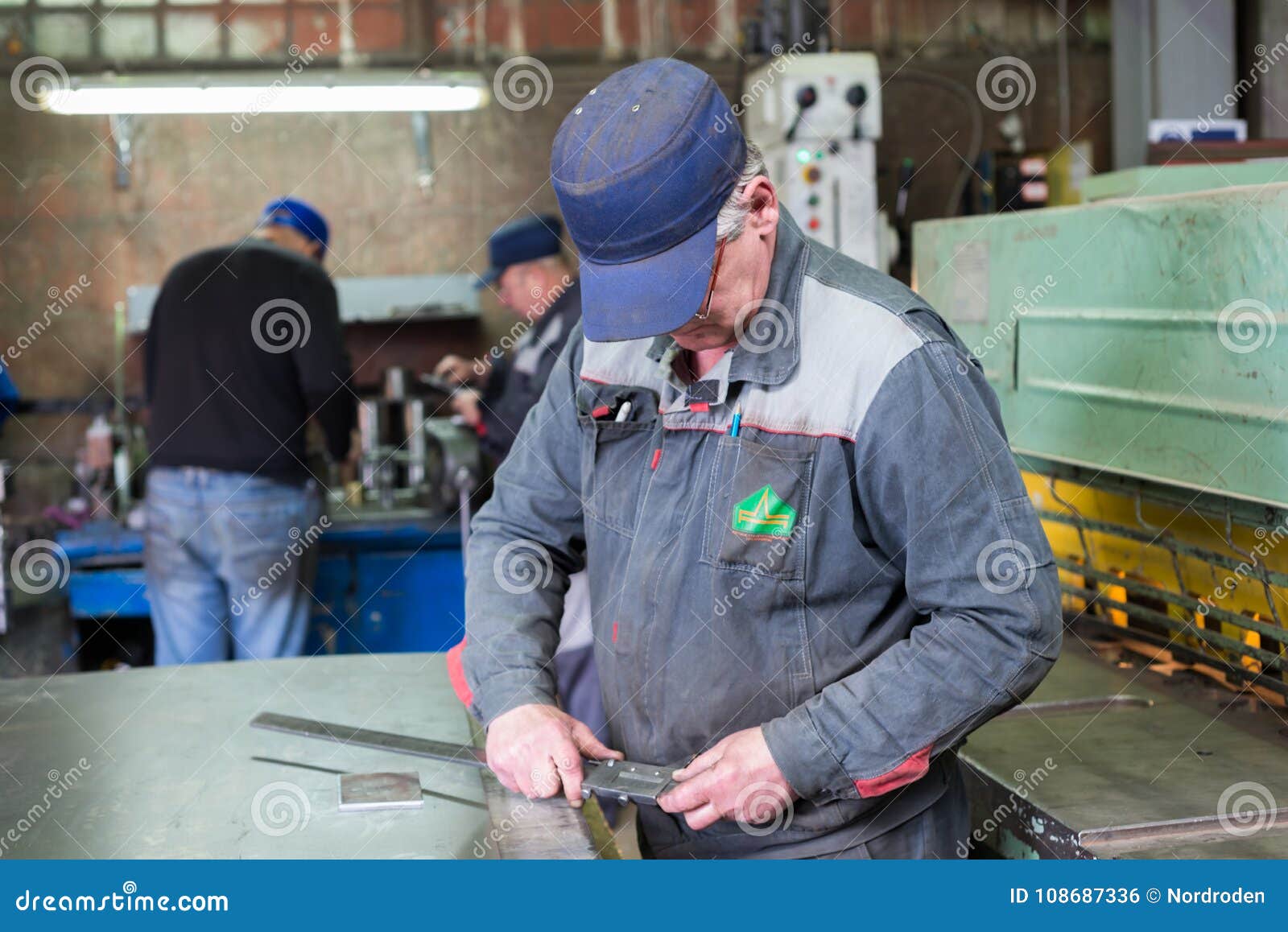 The Locksmith Performs Measurements Using a Caliper. Working with the ...