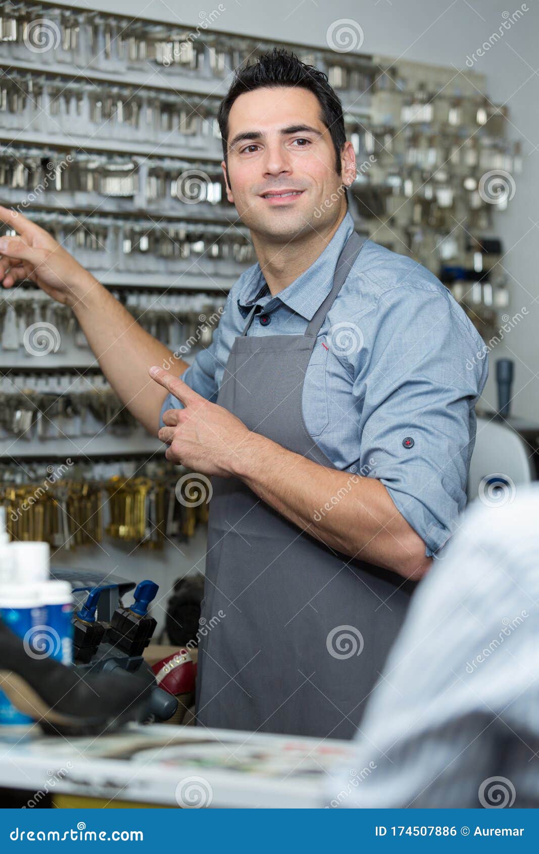 Locksmith Pointing at Key Displays Stock Photo - Image of duplicate ...