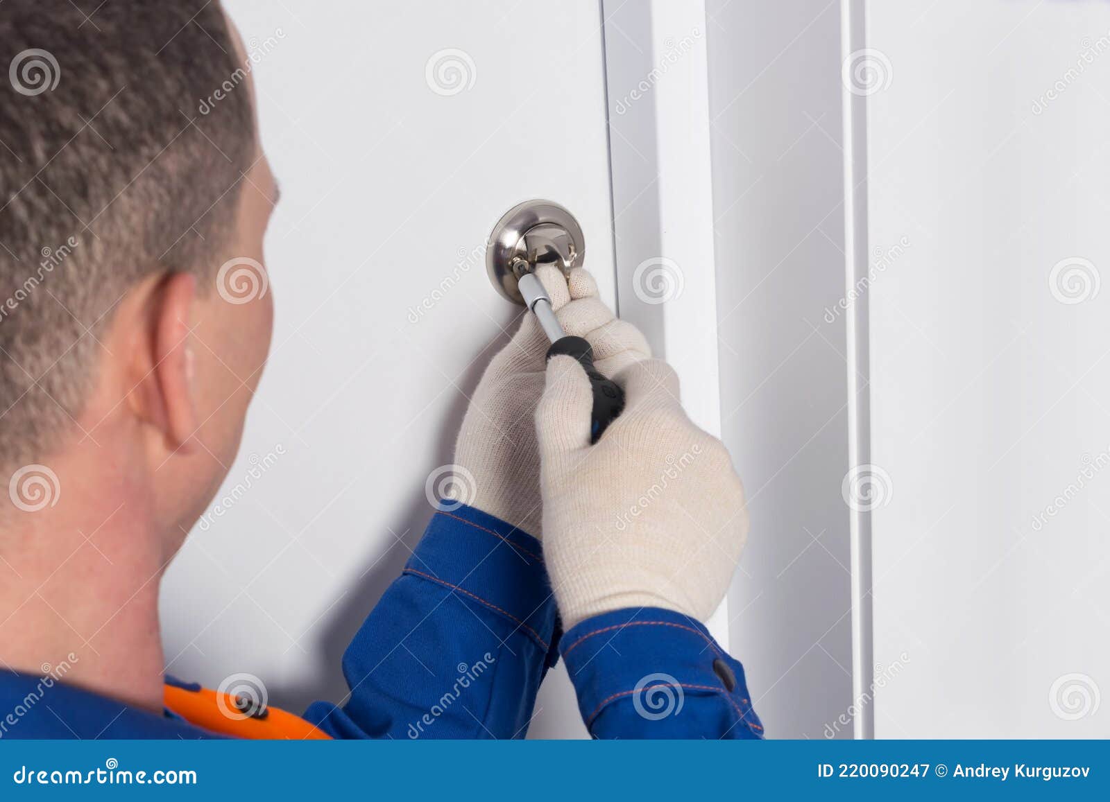 A Locksmith in Uniform, Unscrews the Bolt on the Front Door To Close ...
