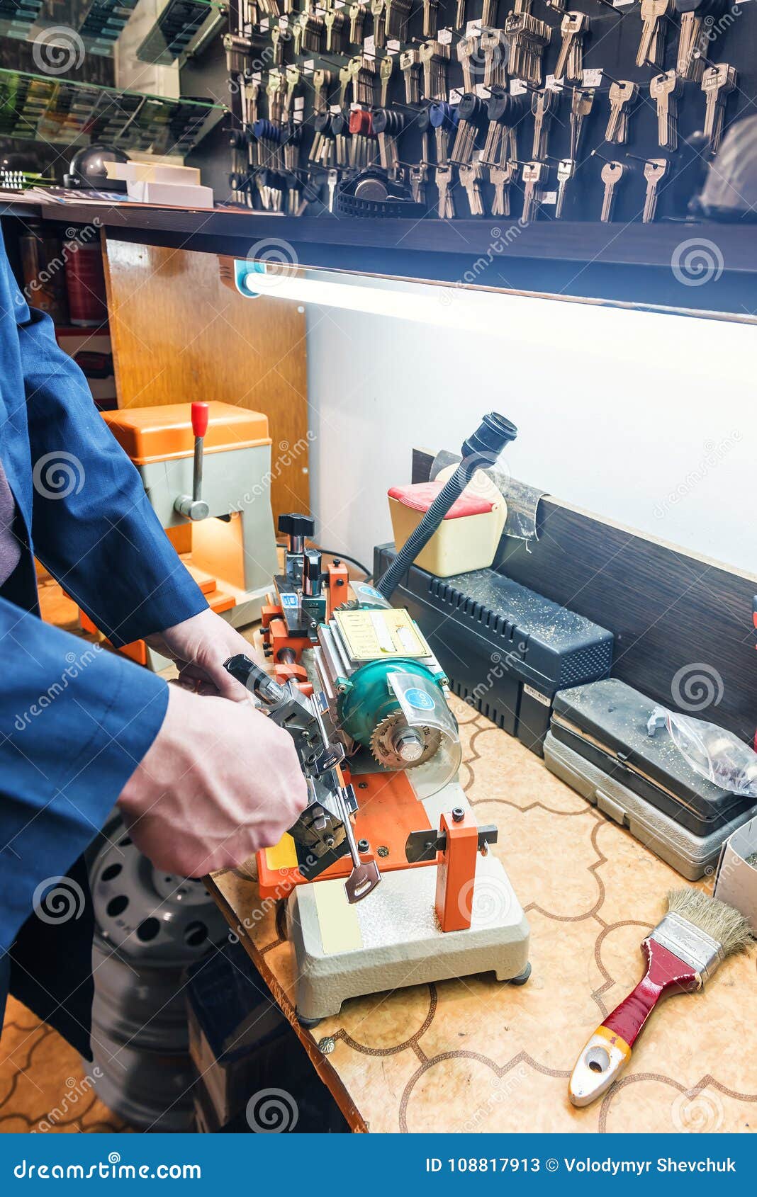 Locksmith makes new key stock image. Image of manufacturing - 108817913