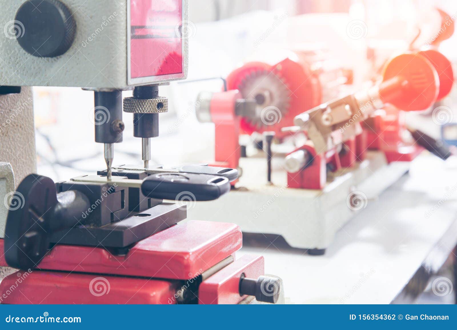 Locksmith in Workshop Makes New Key. Professional Making Key in ...