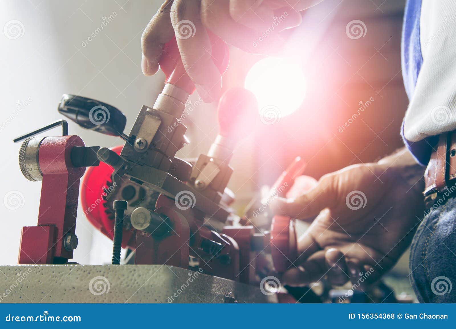 Locksmith in Workshop Makes New Key. Professional Making Key in ...