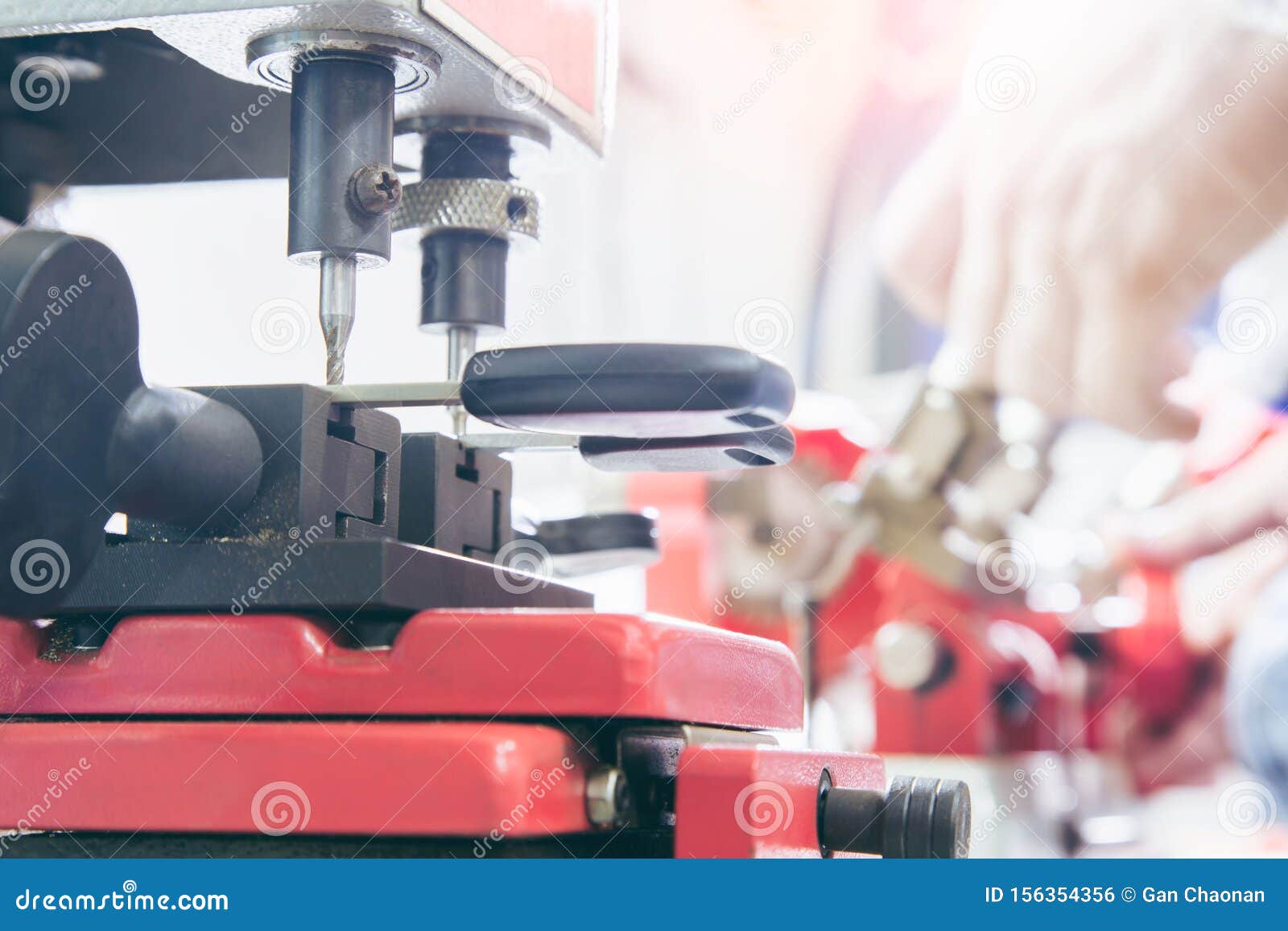 Locksmith in Workshop Makes New Key. Professional Making Key in ...