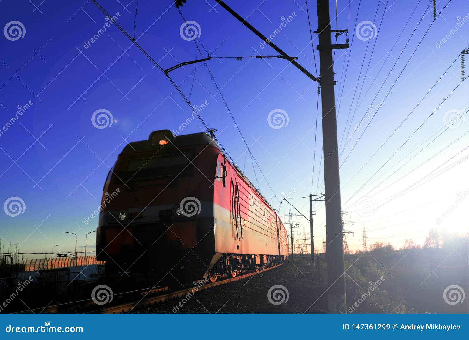 The Locomotive of a Freight Train Carrying Goods. at Sunset. Stock ...