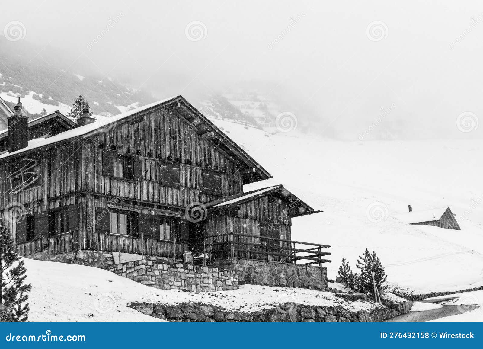 Log Cabin in the Mountains with Falling Snow Stock Photo - Image of ...