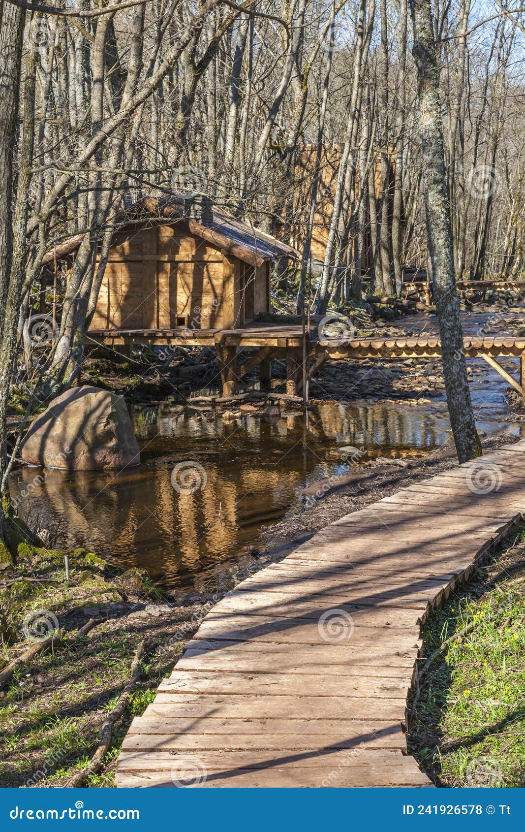 Log Cabin by a River with a Footbridge in a Woodland at Spring Stock ...