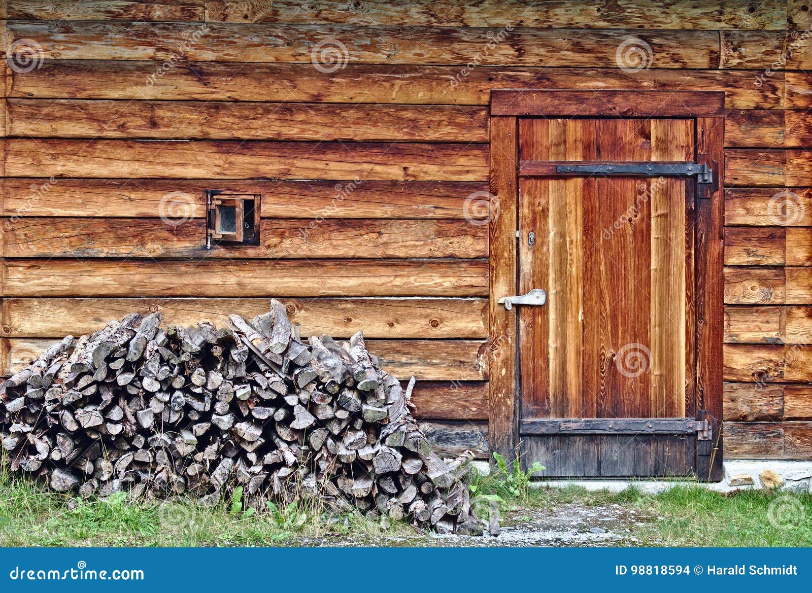 Log Cabin Wall with Small Window, Door and Wood Stack Stock Photo ...
