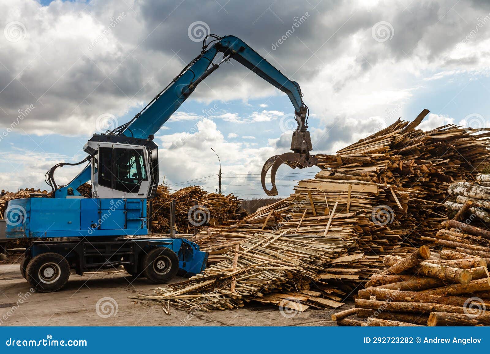 Log Loader or Forestry Machine Loads a Log Truck Stock Photo - Image of ...